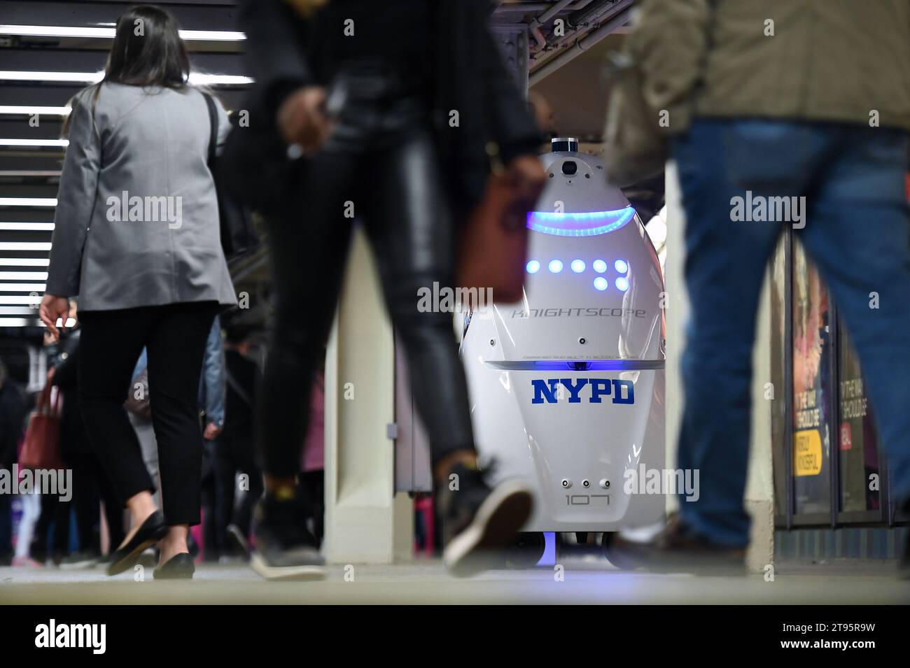 New York, USA. 22nd Nov, 2023. Commuters walk past the NYPD's Knightscope K5 Autonomous Security ...