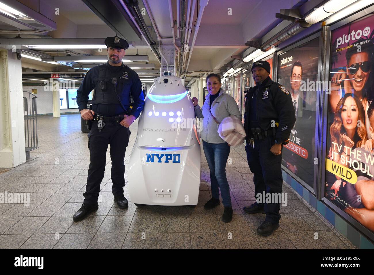 New York, USA. 22nd Nov, 2023. A woman asks to pose with two NYPD officers and the NYPD's ...