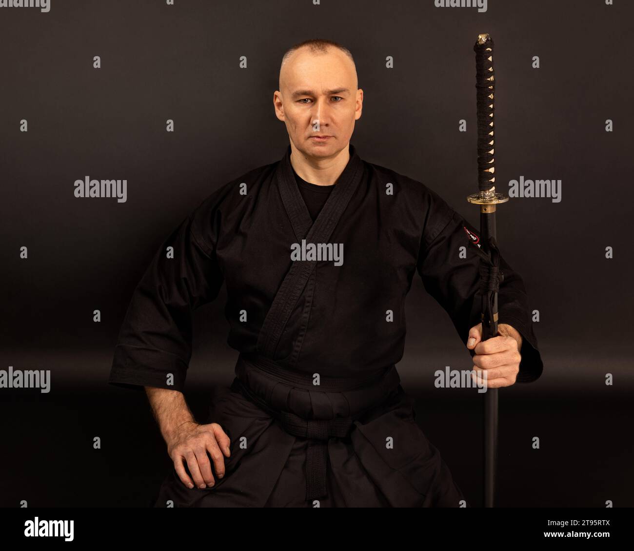 Portrait of aikido sensei master with black sensei belt in taekwondo ...