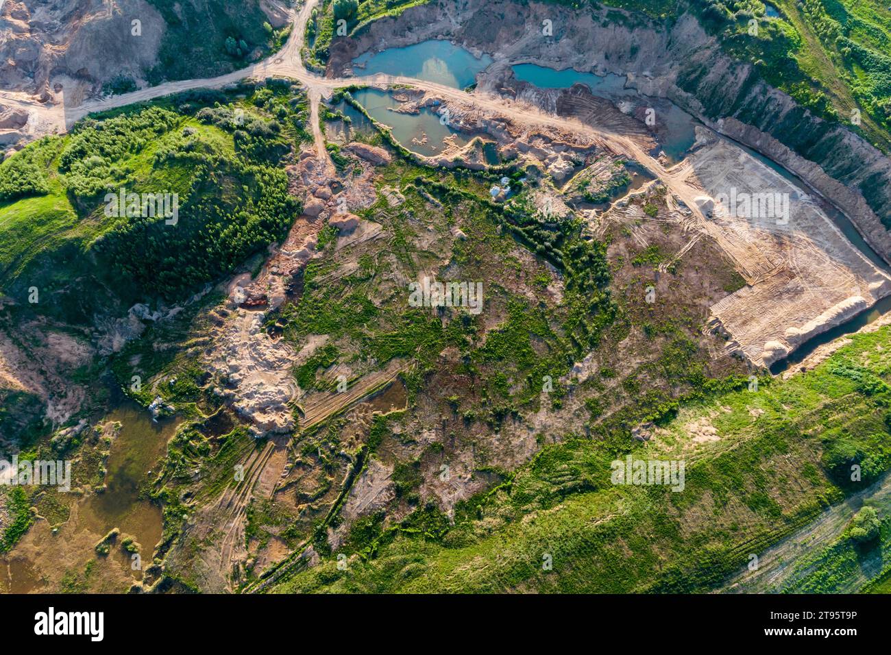 Aerial view of a sand quarry with overgrown slopes Stock Photo - Alamy