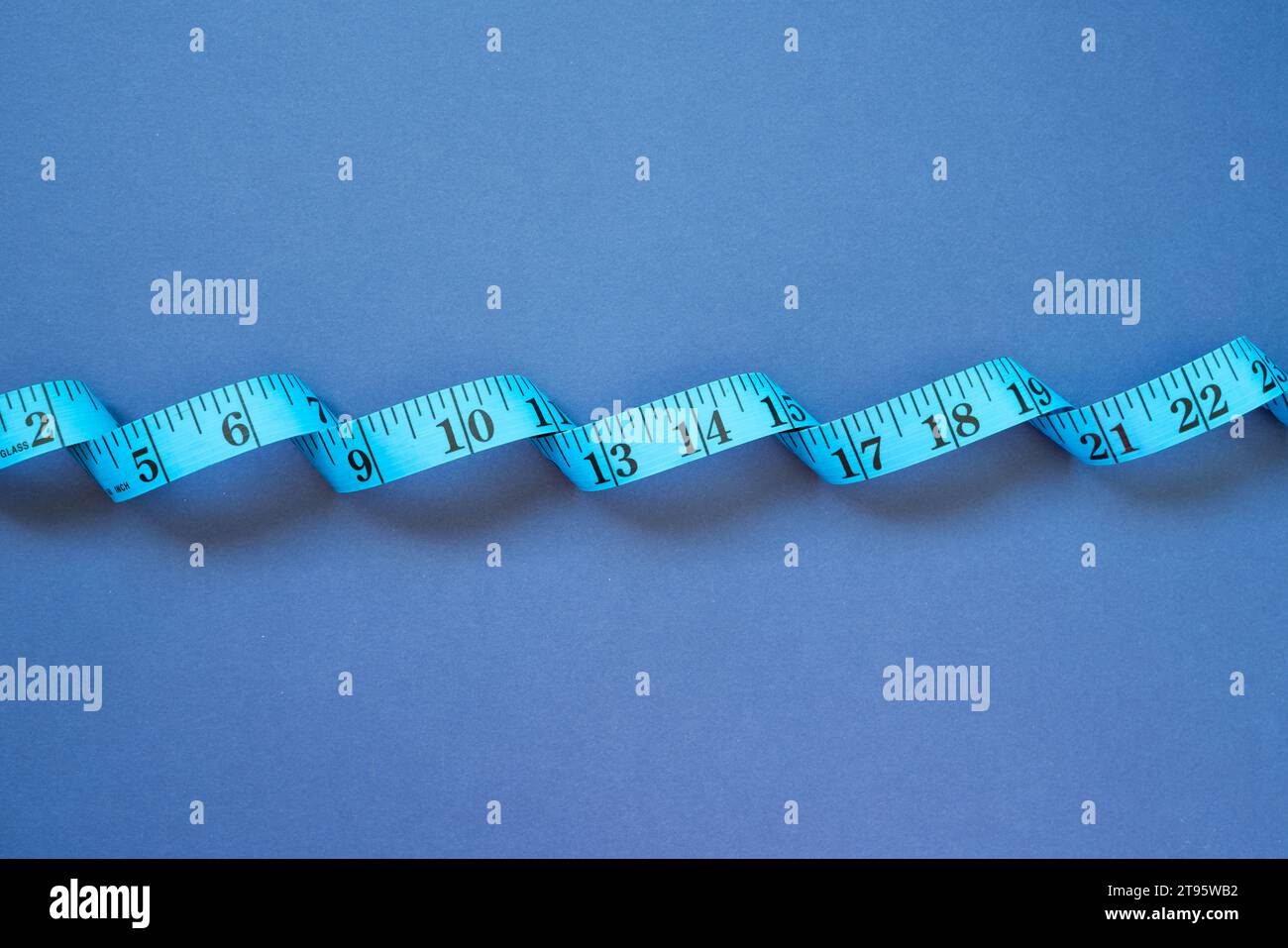 Tape measure on navy blue background. top view Stock Photo - Alamy