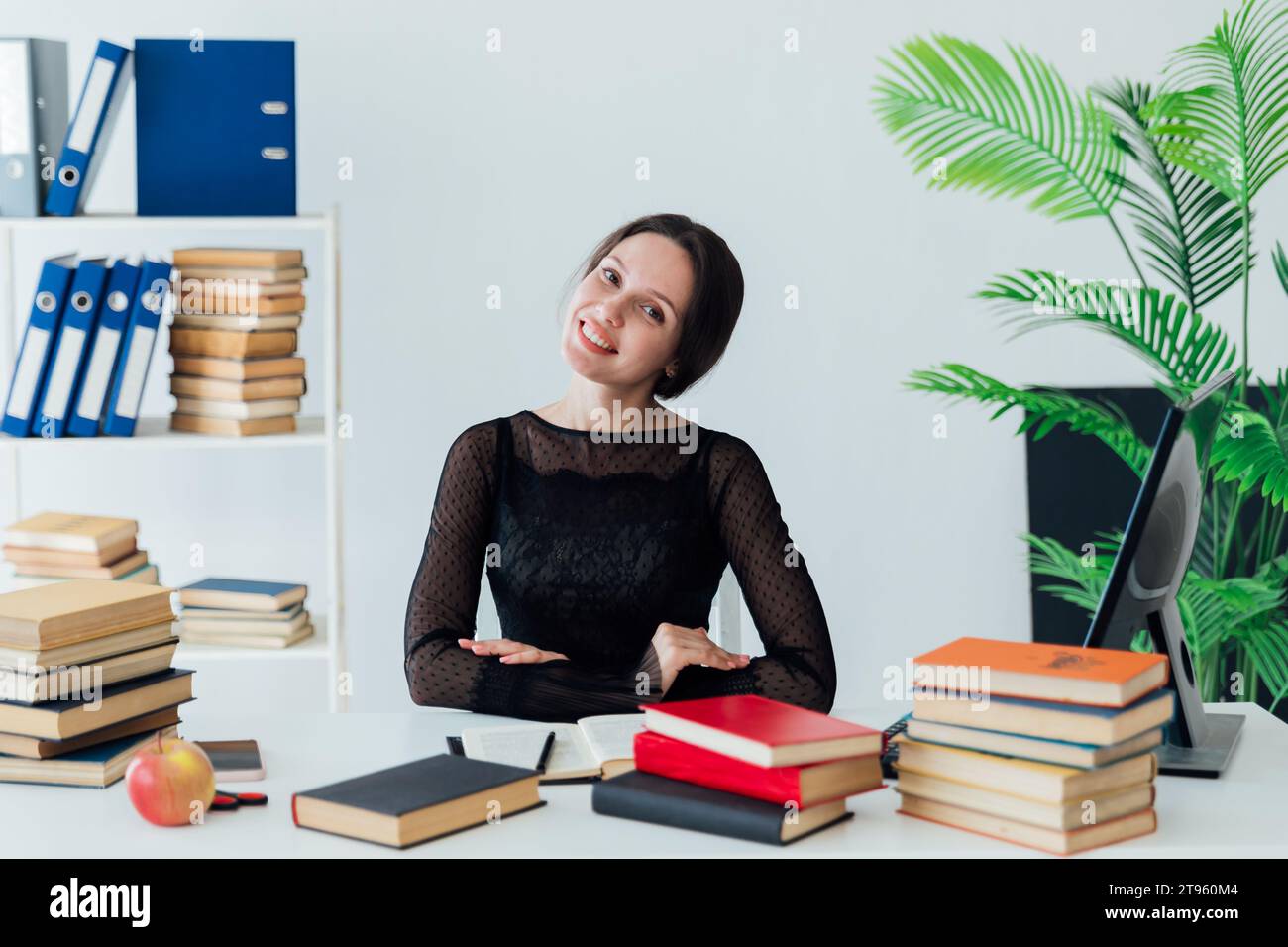 Beautiful business woman with books in office in office training ...