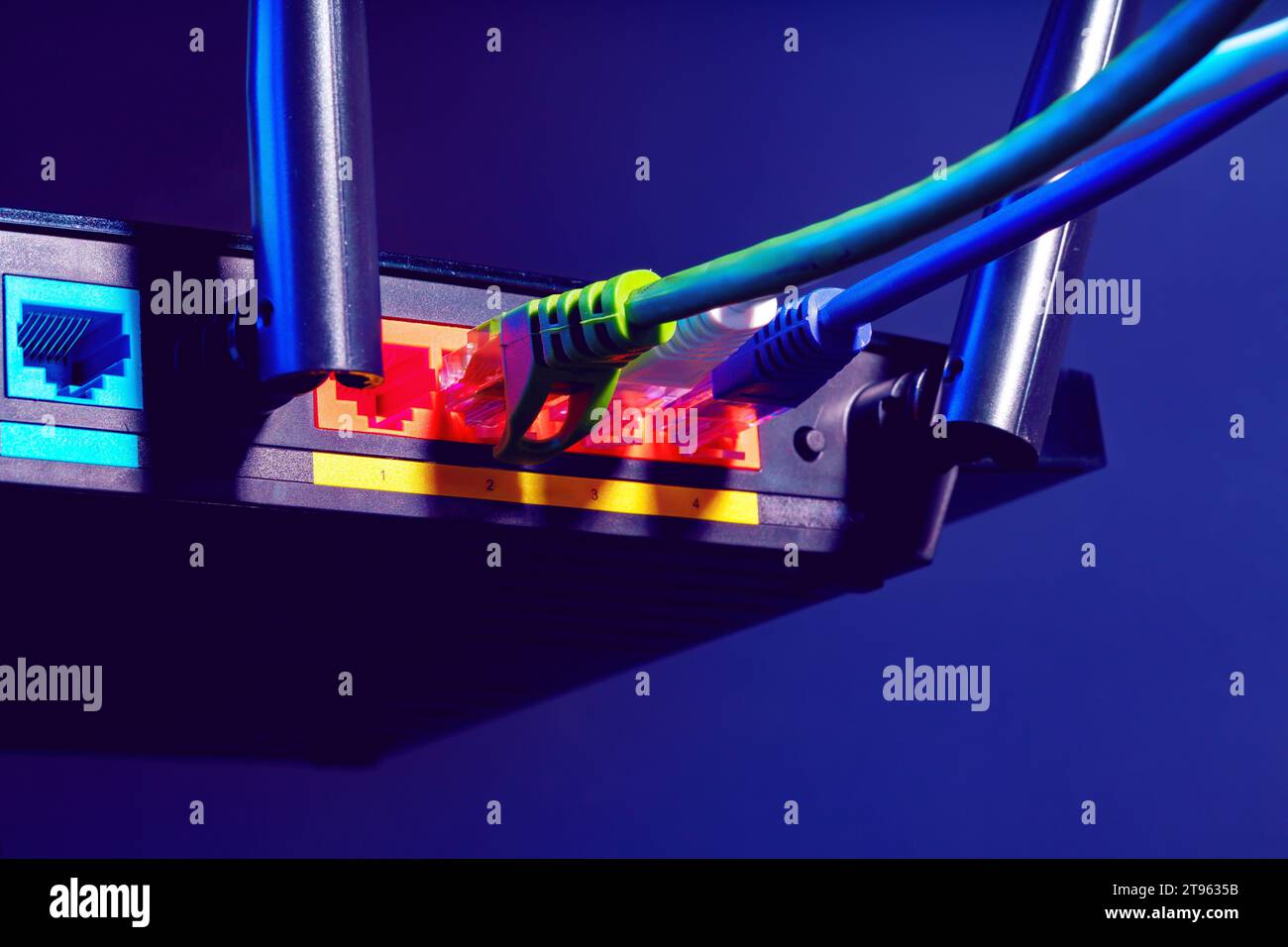 Cables plugged in a Wi-Fi router on dark background Stock Photo - Alamy