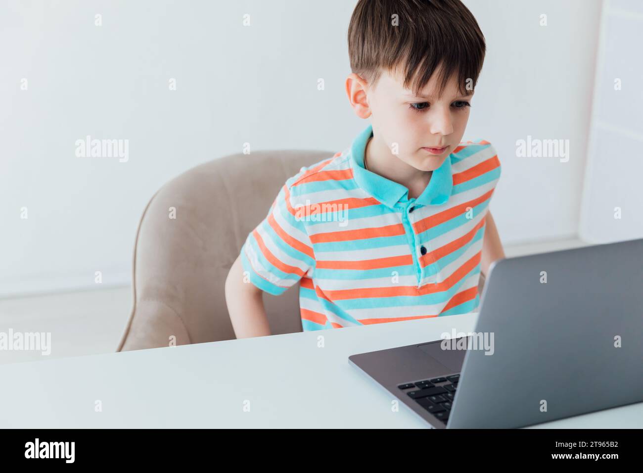 Boy doing learning task at school on computer Stock Photo - Alamy