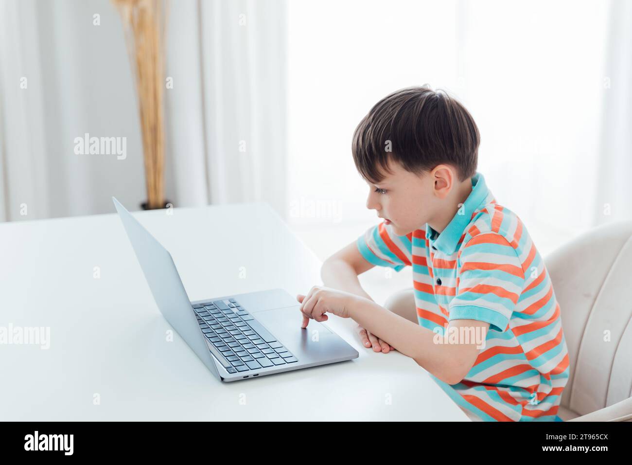 Boy doing learning task at school on computer Stock Photo - Alamy
