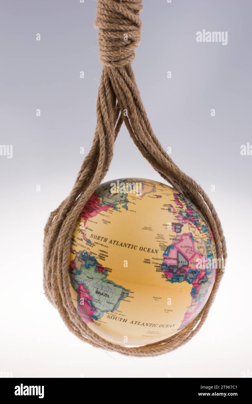 Globe hanging in rope on white background Stock Photo - Alamy