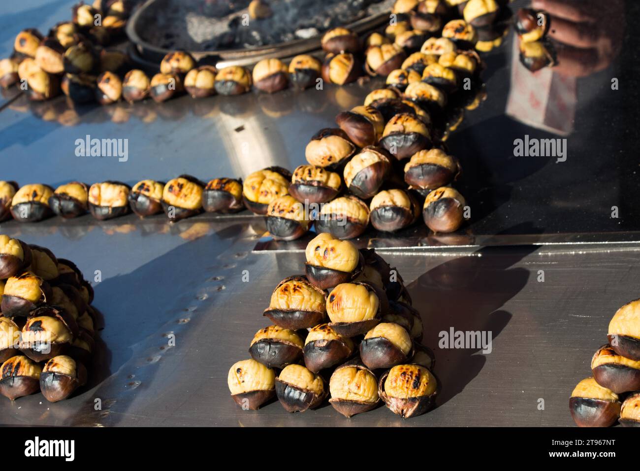 Organic brown chestnuts roasted over a hot fire Stock Photo - Alamy