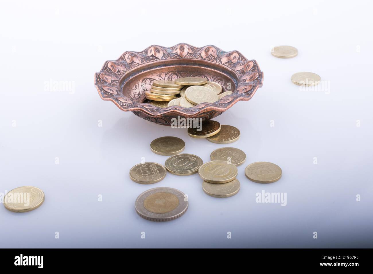 Coins inside and around a metal plate Stock Photo - Alamy