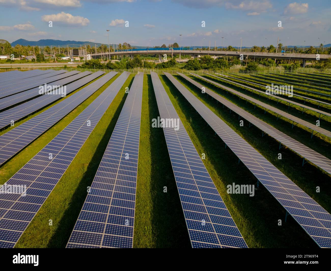 Sun power solar panel field near a highway road with traffic, Solar ...