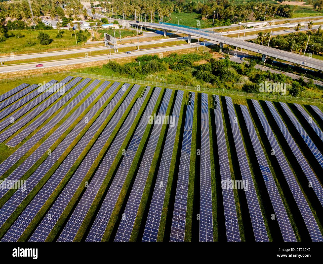 Sun power solar panel field near a highway road with traffic, Solar ...