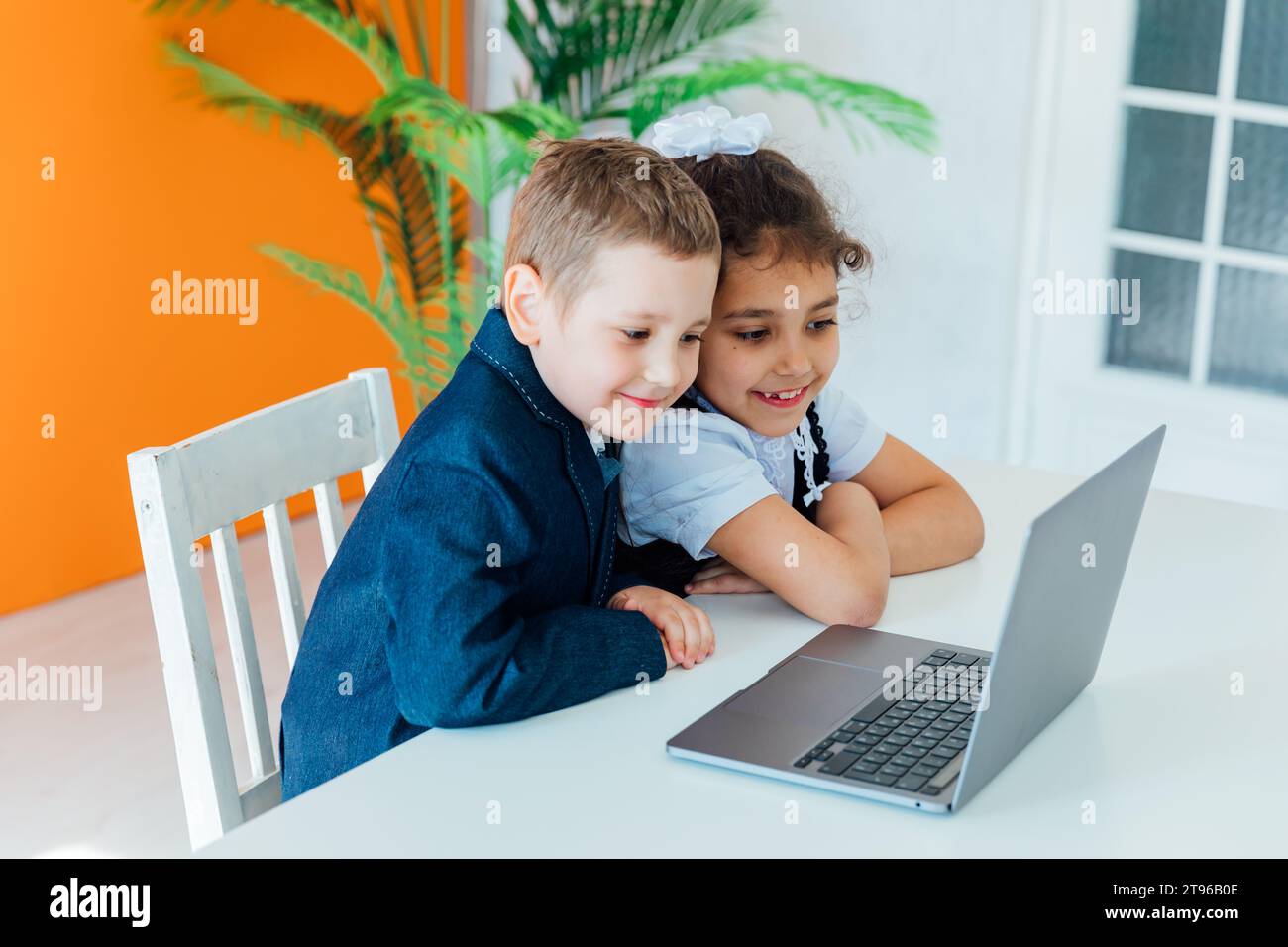 Boy and girl learning watching laptop Stock Photo - Alamy