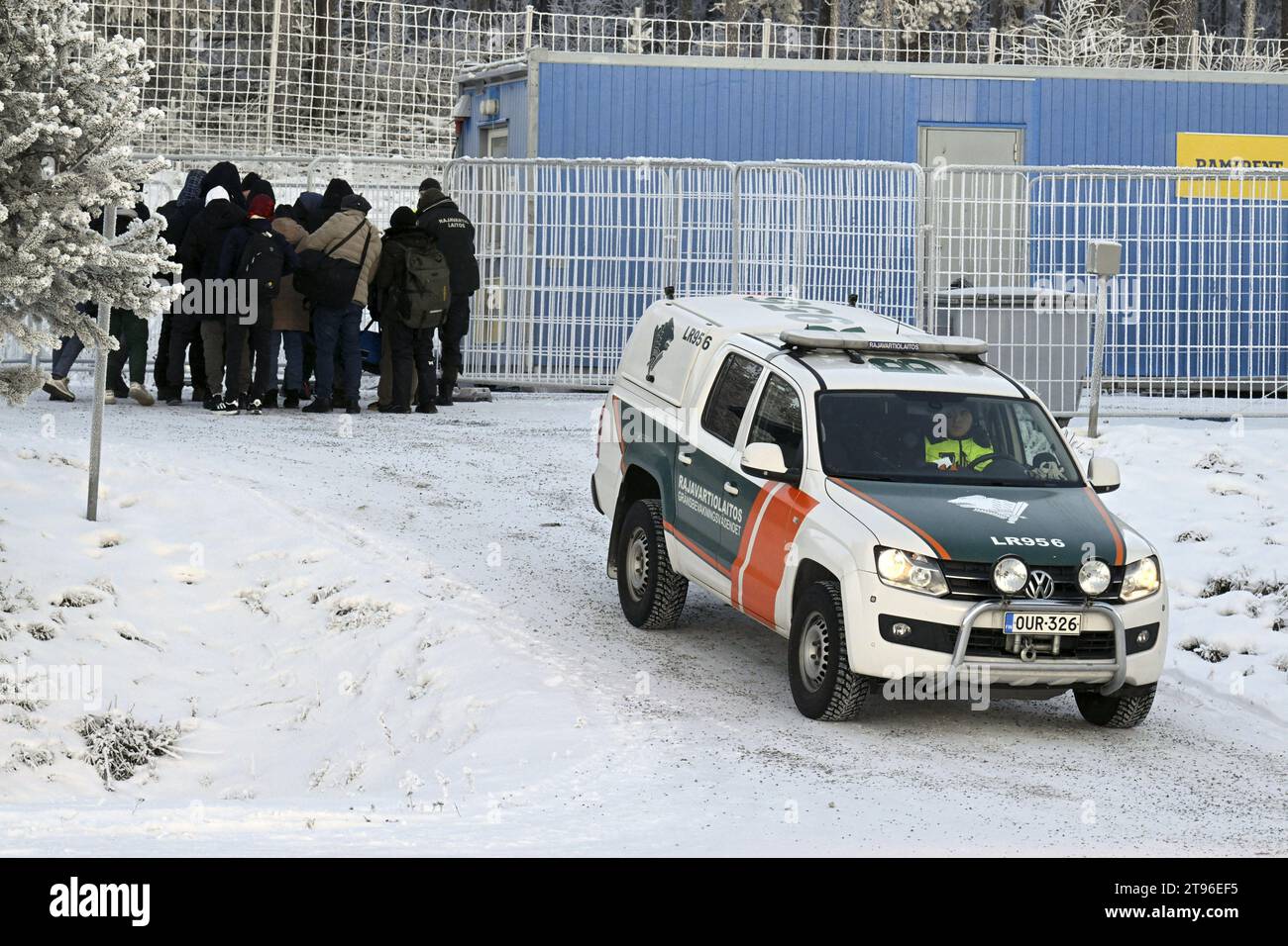 Salla, Finland. 22nd Nov, 2023. Refugees and a vehicle of the Finnish ...