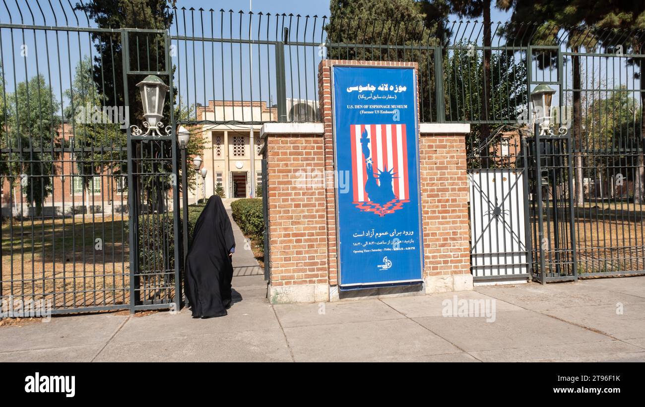 Woman in hijab walking near main entrance to the former US Embassy in ...