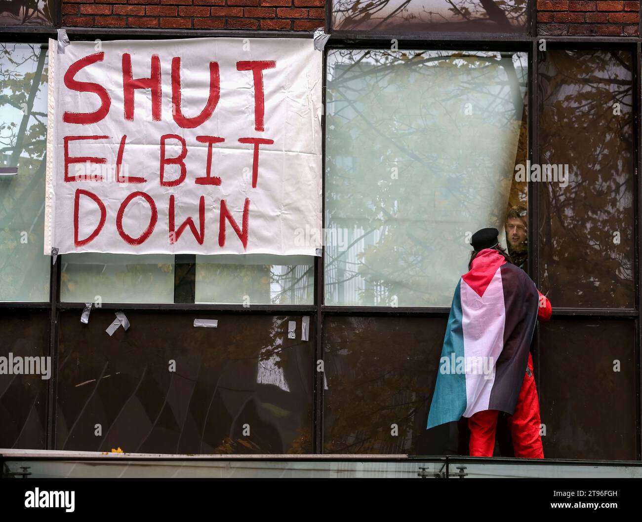 A Palestine Action activist on the glass roof where Fisher German has ...