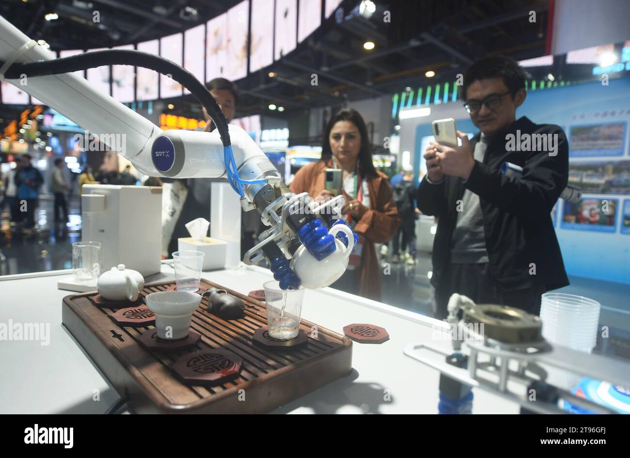 HANGZHOU, CHINA - NOVEMBER 23, 2023 - Visitors watch robots make tea ... HANGZHOU, CHINA - NOVEMBER 23, 2023 - Visitors watch robots make tea ...
