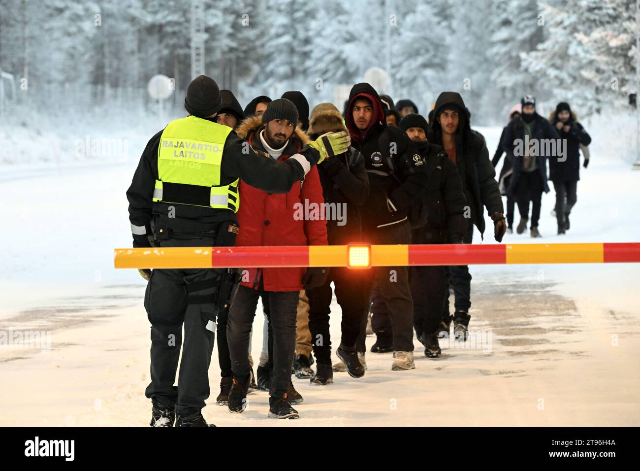 Salla, Finland. 22nd Nov, 2023. Finnish Border Guard speaks to the ...