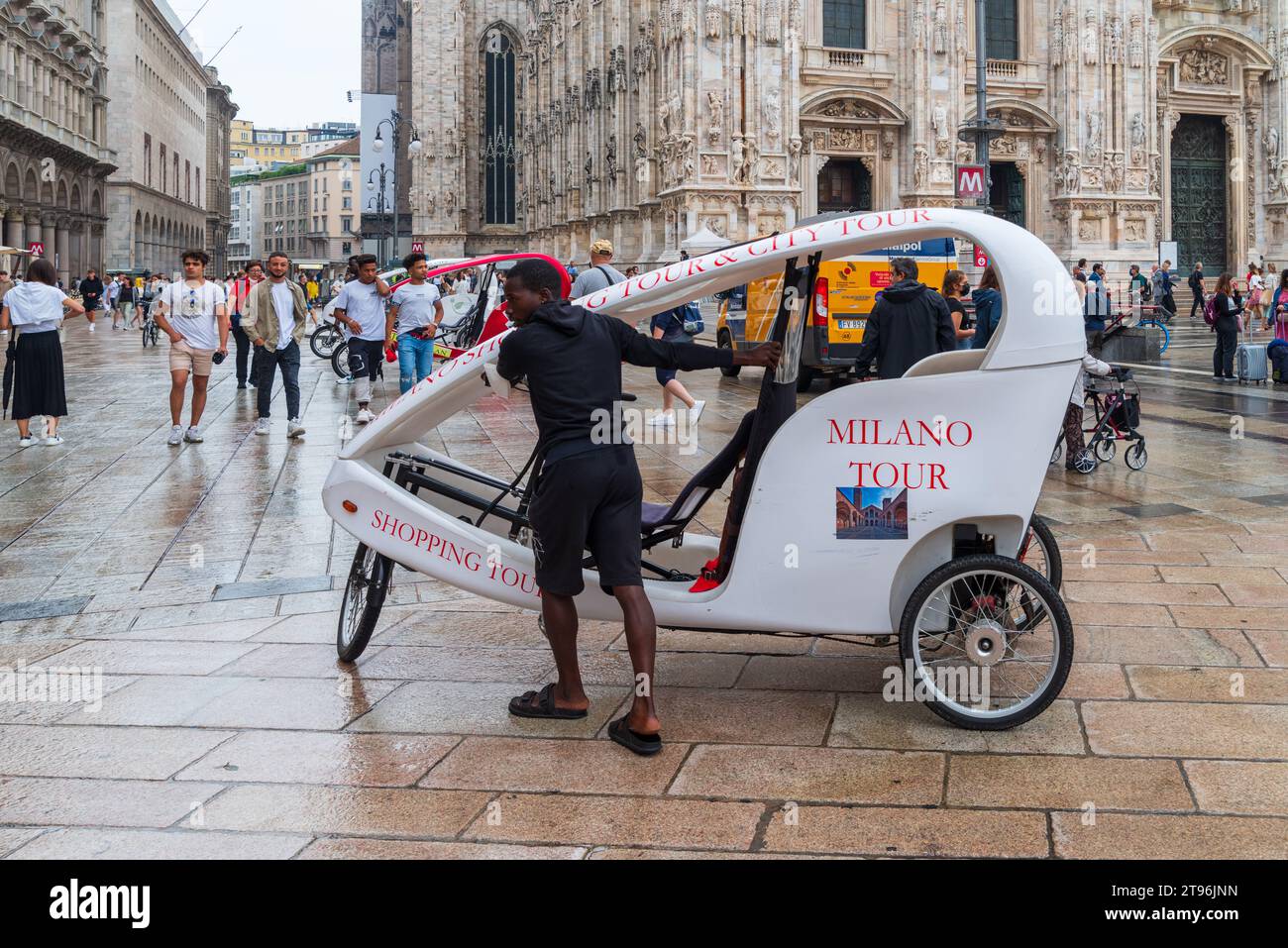 MILAN, ITALY - AUGUST 4, 2021: Street vendor offering bike rides in his ...