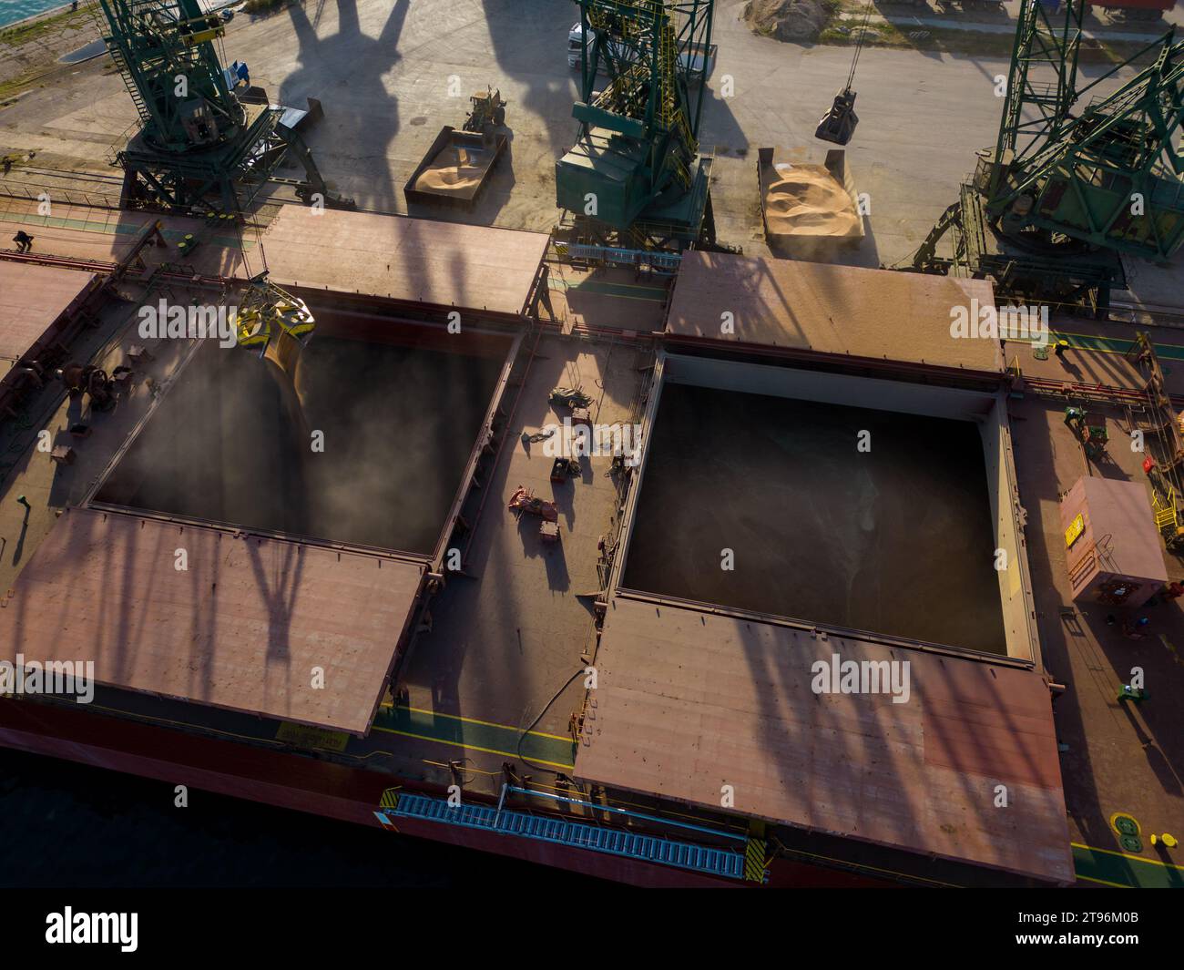 Aerial view of big cargo ship bulk carrier is loaded with grain of ...