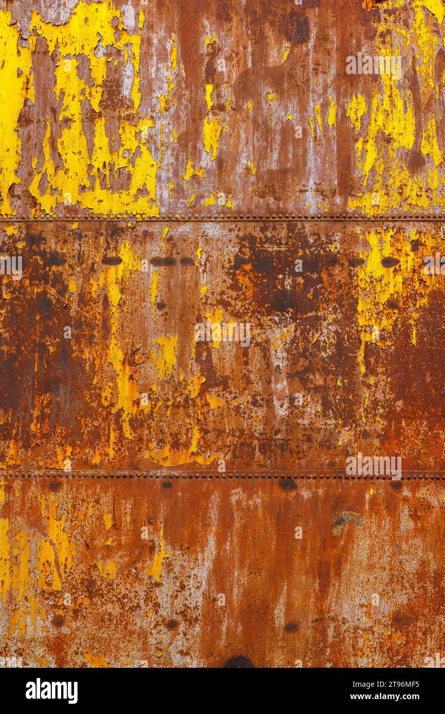 beautifully rusted rivetted sheet metal with leftovers of yellow paint ...