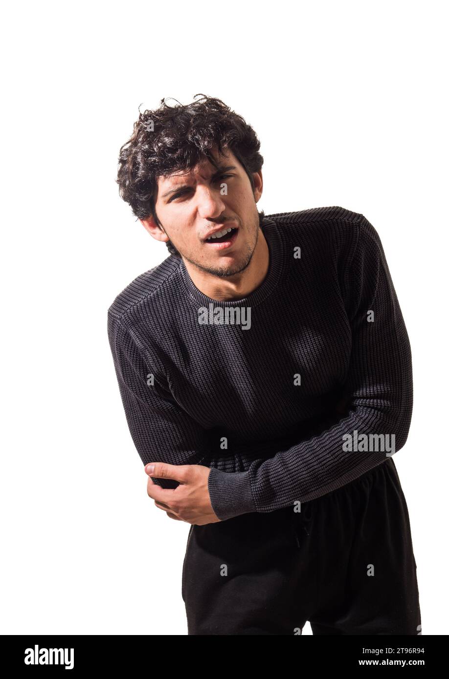 A young man is suffering from belly-ache, stomach ache, in a black ...