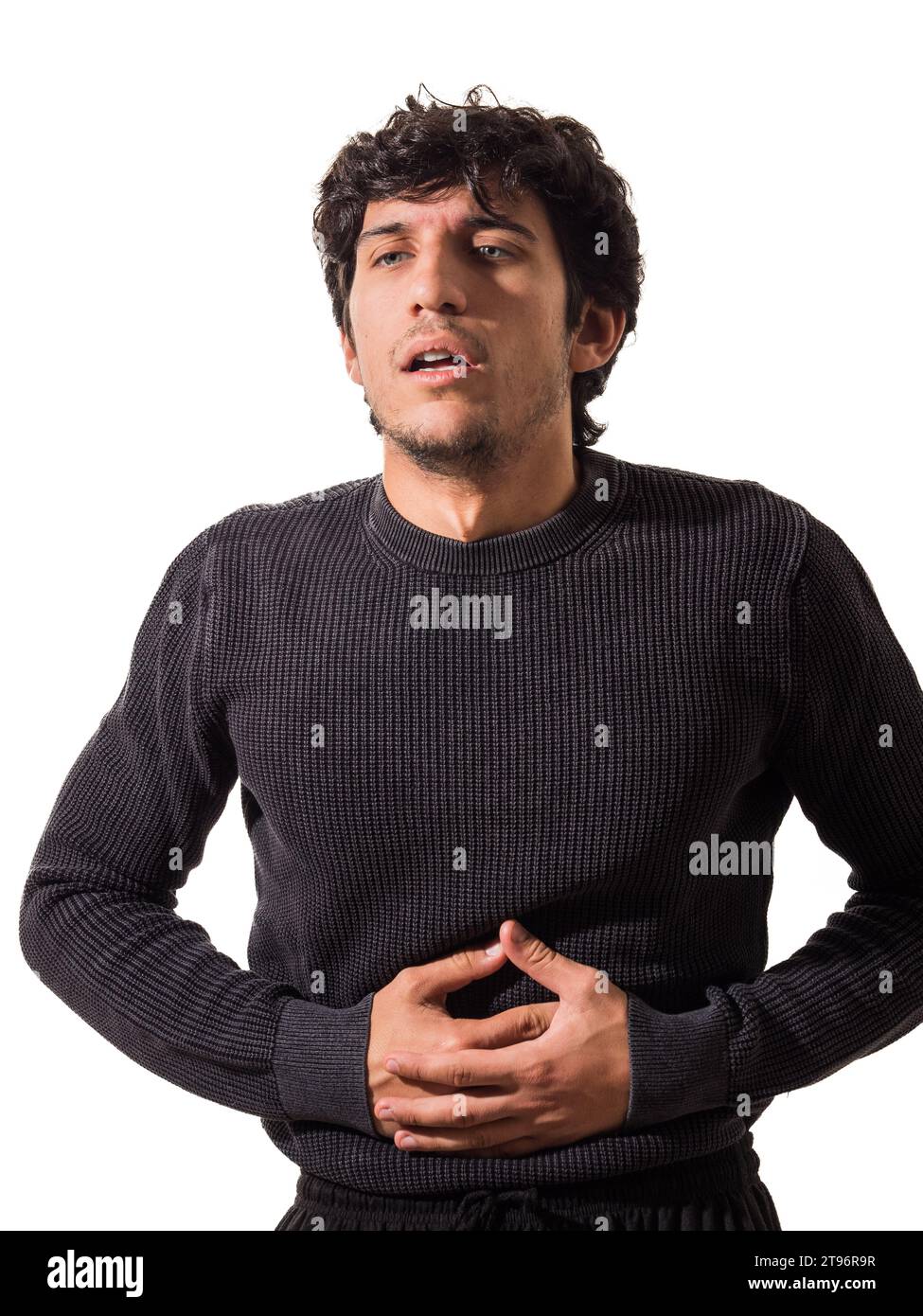A young man is suffering from belly-ache, stomach ache, in a black ...