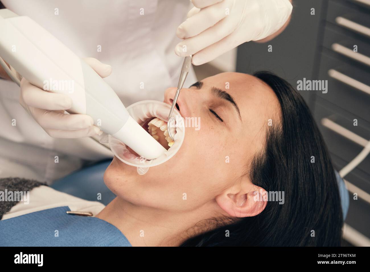 High angle of faceless dentist in latex gloves holding dental tools ...