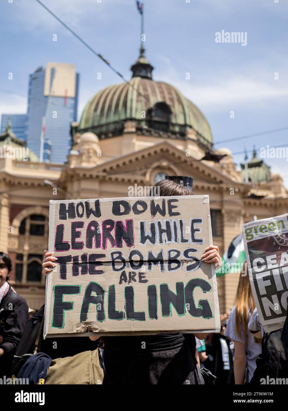Melbourne, Australia. 23rd Nov, 2023. A student demonstrator holds a ...