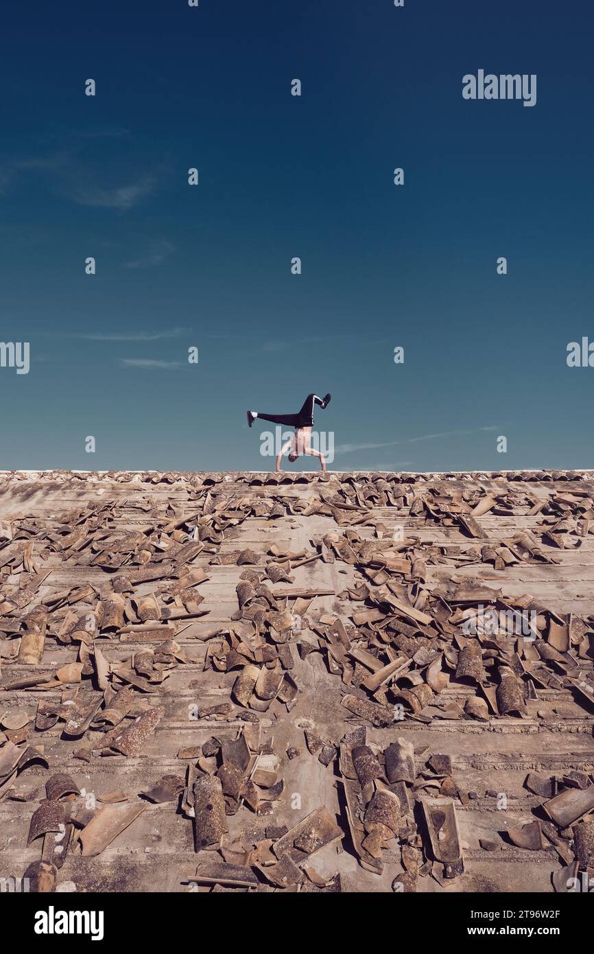 From below of unrecognizable male performing breakdance element on ...