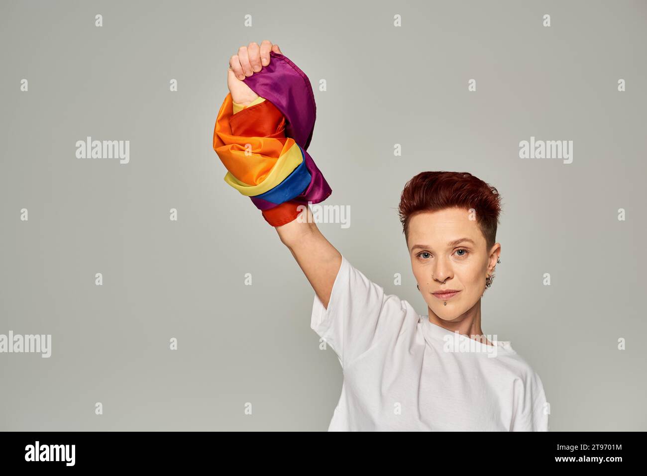 confident redhead bigender person in white t-shirt and jeans standing ...