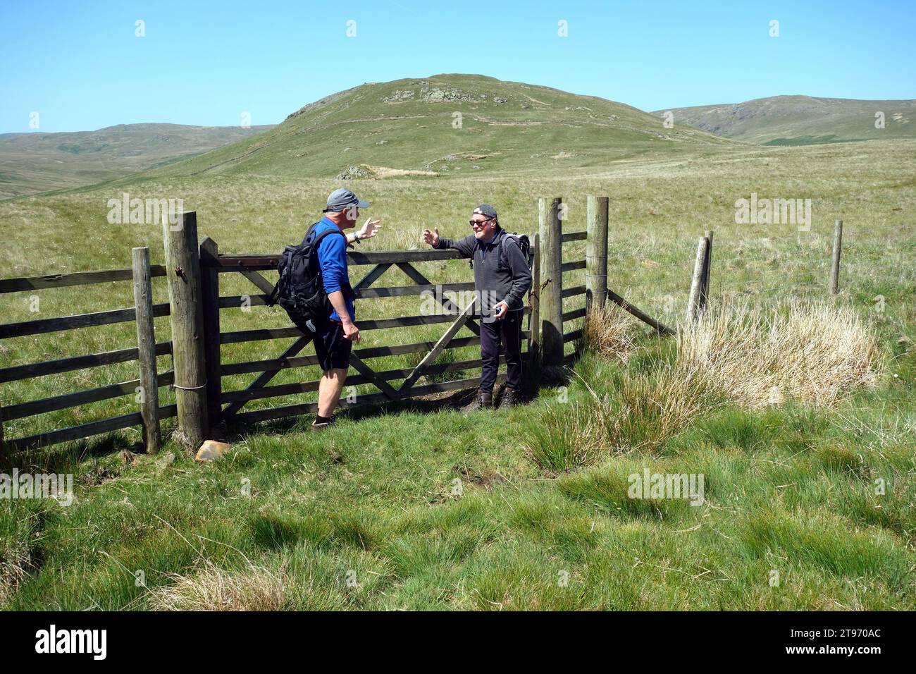Two Men Talking by Wooden Gate in front of Wainwright's Outlying Fell ...
