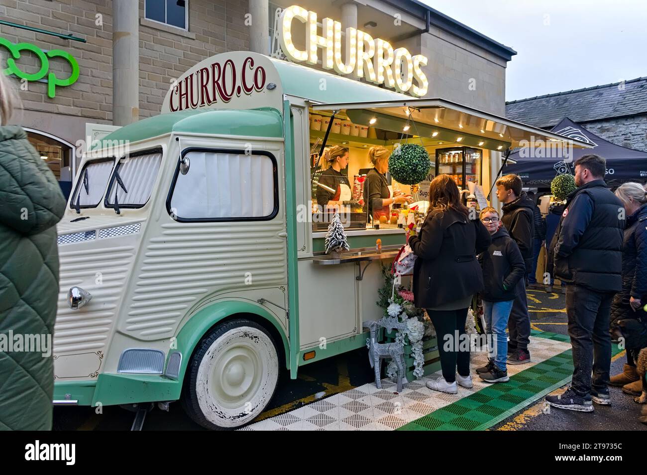 People queueing at a Citroen food van called CHURROS at the Christmas ...