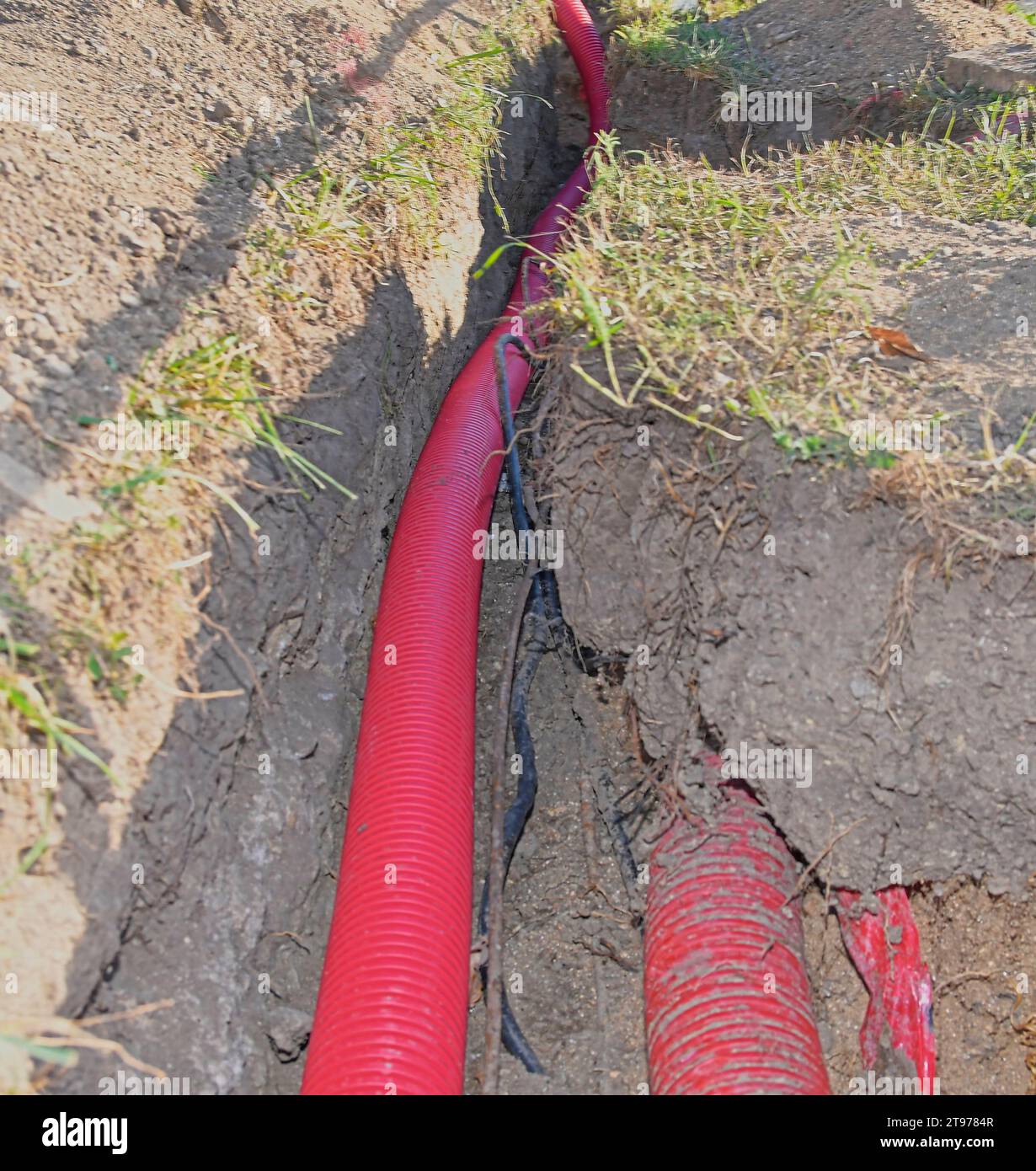 Cables in the trench. High voltage cables in protective red cover in ...