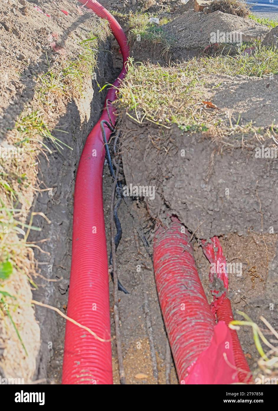 Cables in the trench. High voltage cables in protective red cover in ...