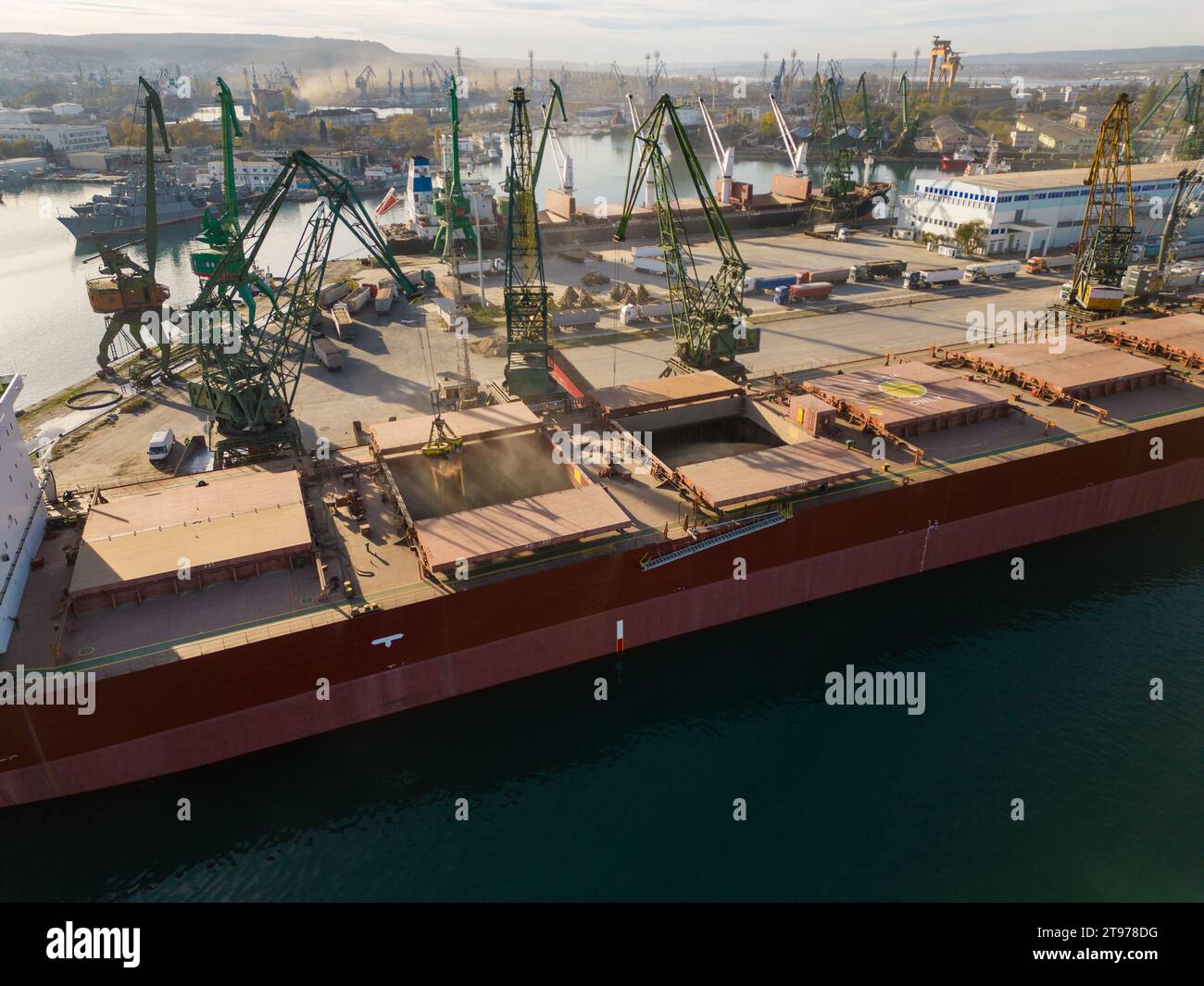 Aerial view of big cargo ship bulk carrier is loaded with grain of ...