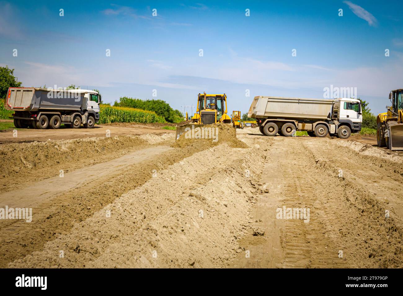 Earthmover with caterpillar is moving earth on the building site parked ...