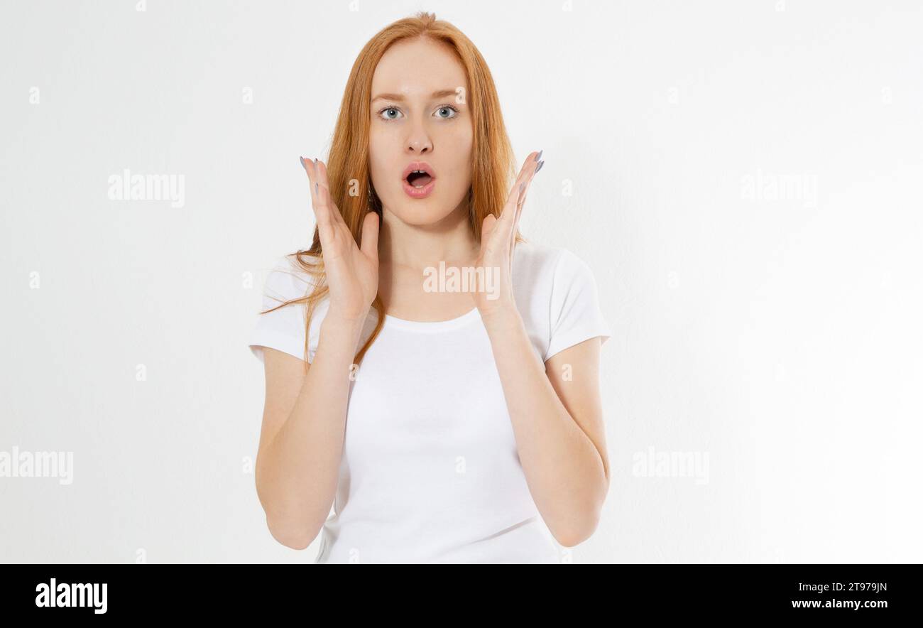 cute surprised redhead girl making fun, isolated on white background ...