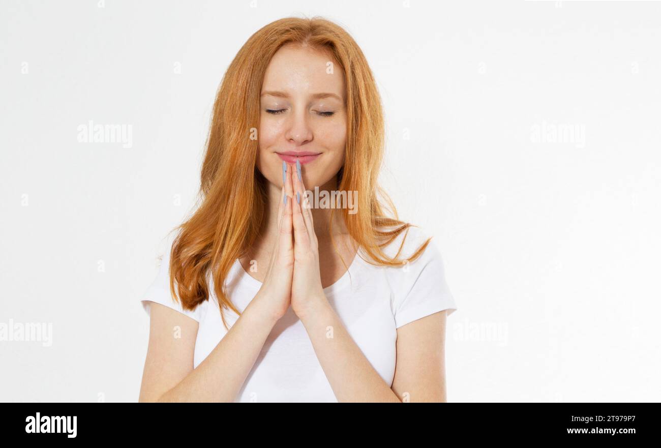 Closeup portrait of a young red head woman praying. Red hair beautiful ...