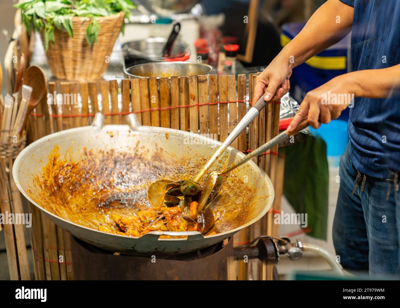 Chef cooking stir-fried seafood in Yellow Curry Paste on pan in street ...
