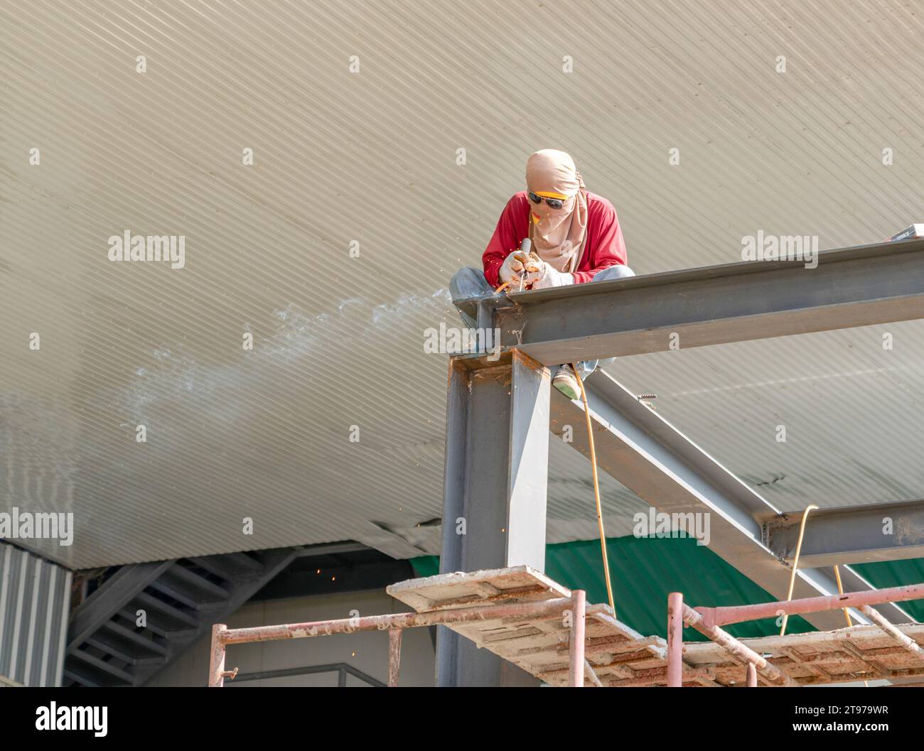 Construction workers welding head pole in an Industrial Factory Stock ...