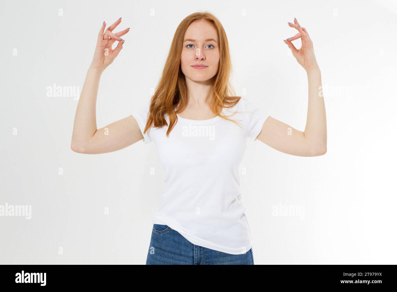 Red hair teen lady in zen pose poratrait on light background ...