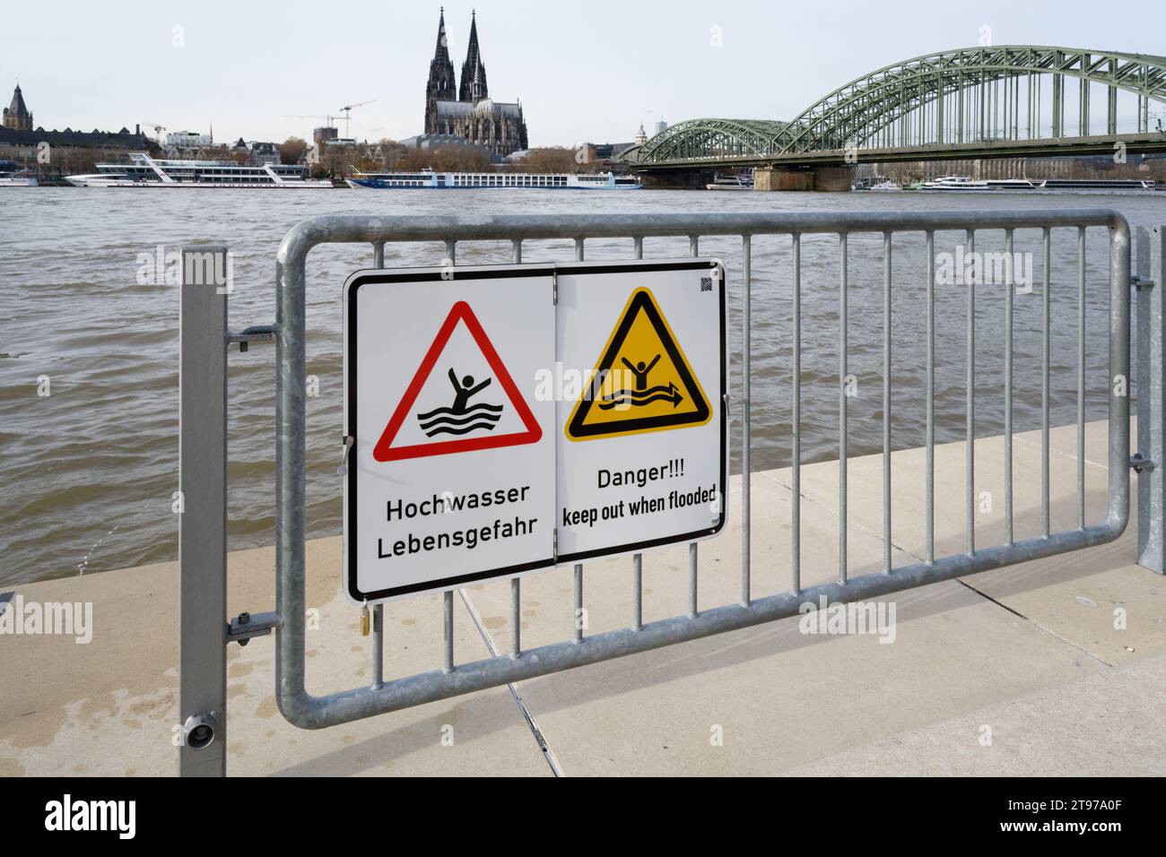 signs warning of flooding in german and english on the banks of the ...