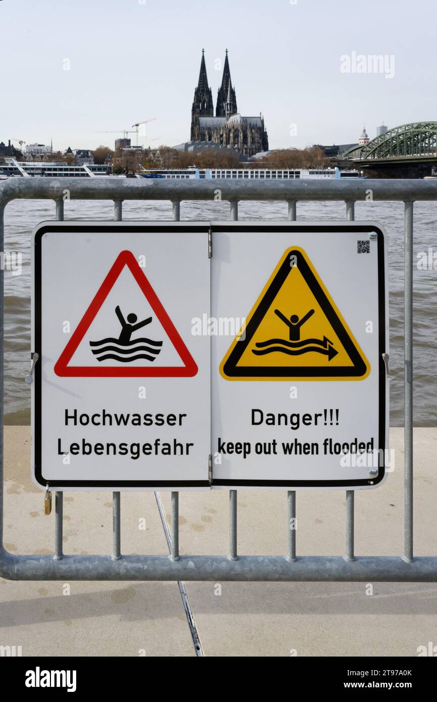signs warning of flooding in german and english on the banks of the ...