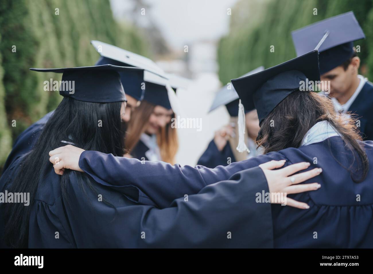 Graduating students celebrate their achievement, hugging and smiling in ...