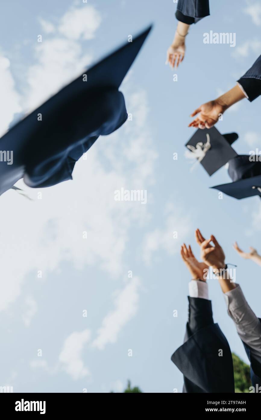 A joyful group of university graduates celebrating their achievements ...