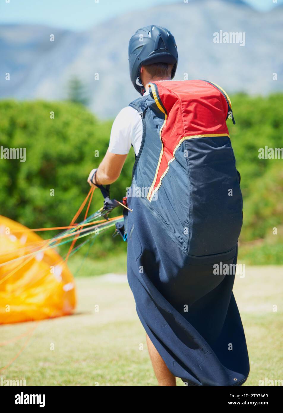 Nature, man and parachute with ground for sport preparation, strings ...