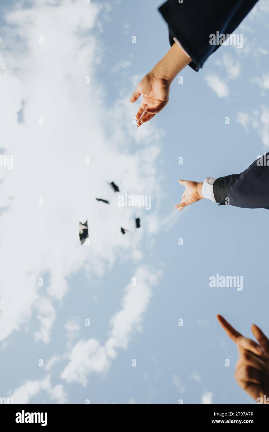 Students throw caps in the air, congratulating graduation each other ...