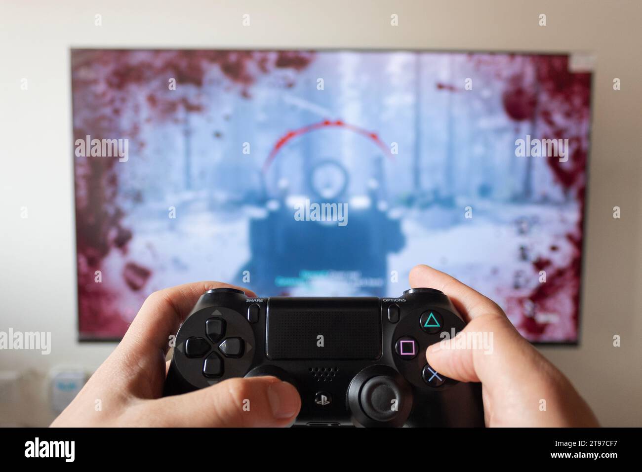 A male hand holding a play station 4 controller with call of duty world ...