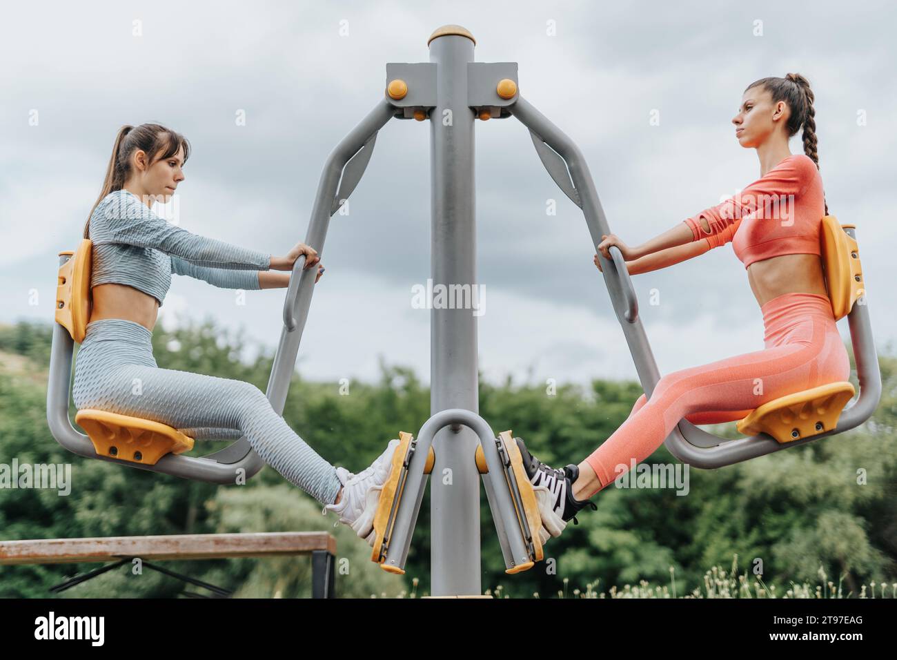 A diverse group of active, fit girls engage in sports exercises and ...