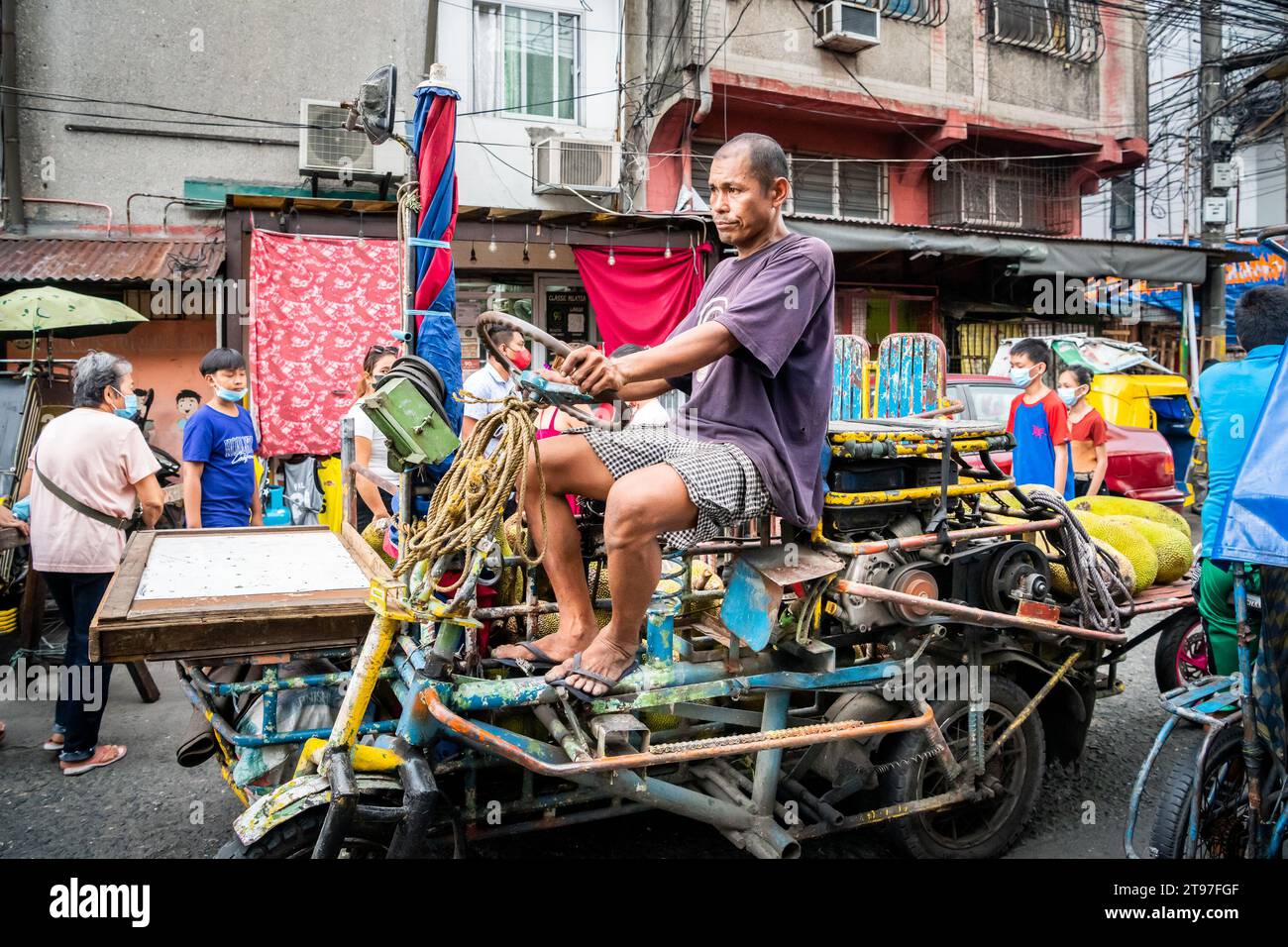 A Filipino worker make a delivery of goods on a tractor style truck in ...