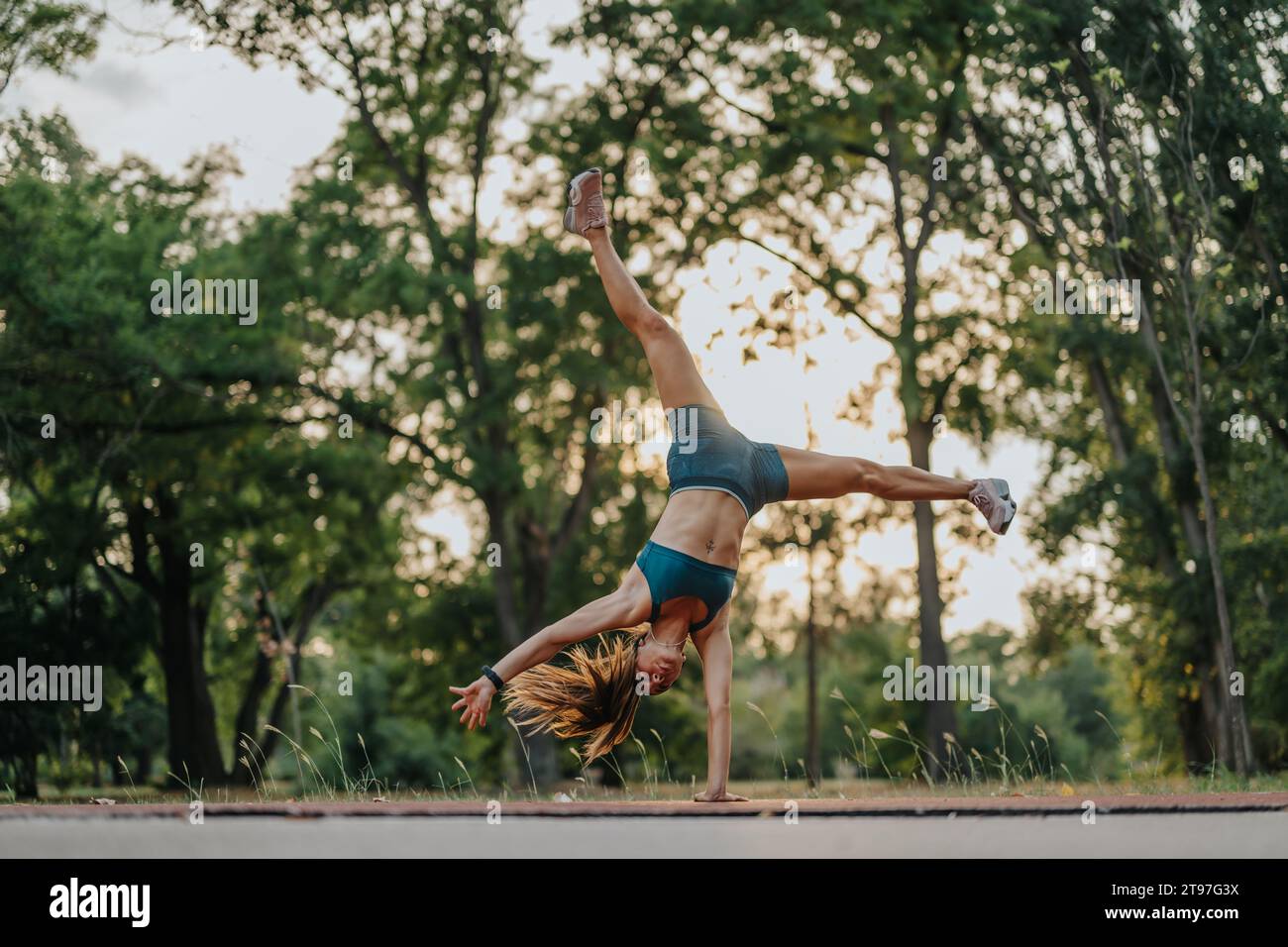 Flexible Female Athlete Show Impressive Cartwheel Skills Outdoors Stock ...